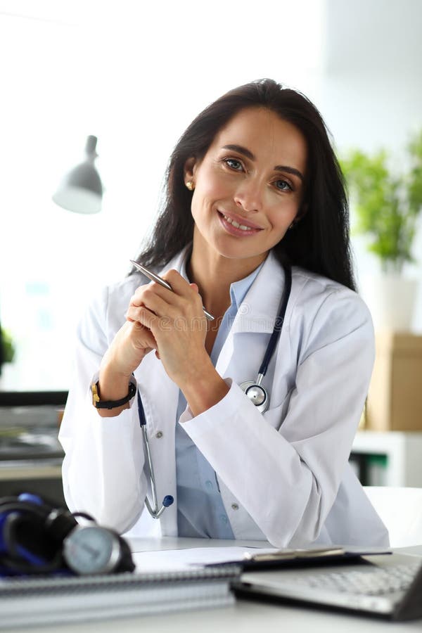 Female GP Sitting at Worktable in Office Stock Image - Image of ...