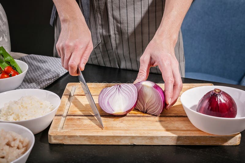 Female Graceful Hands Cut Red Onion on a Cutting Board. Chef at Work in ...