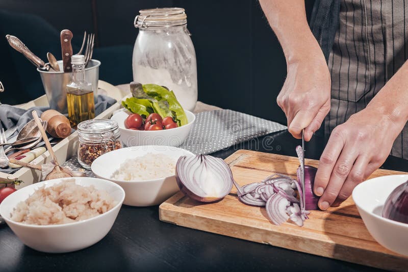 Female Graceful Hands Cut Red Onion on a Cutting Board. Chef at Work in ...