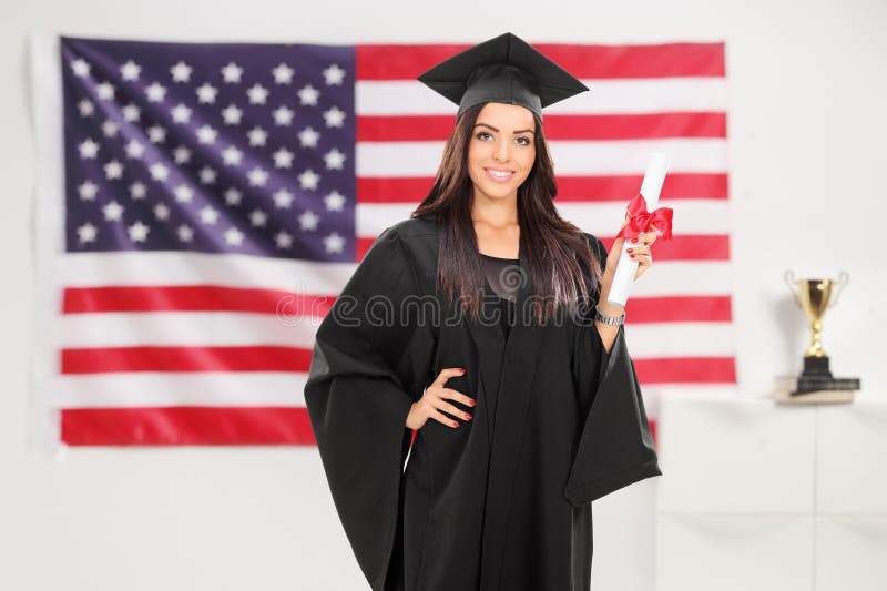 Female Graduate Student Holding a Diploma in Front of American Flag ...