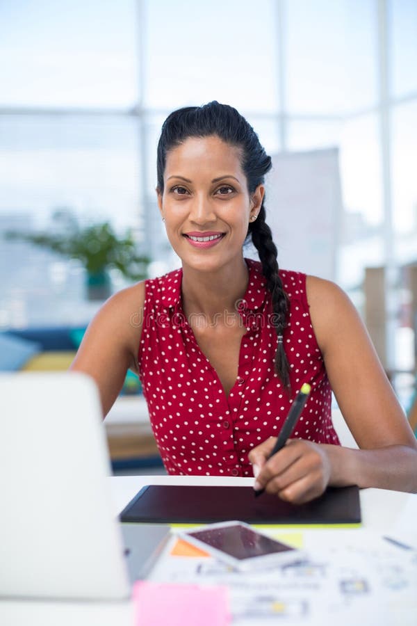 Female Graphic Designer Using Digital Tablet at Desk Stock Photo ...
