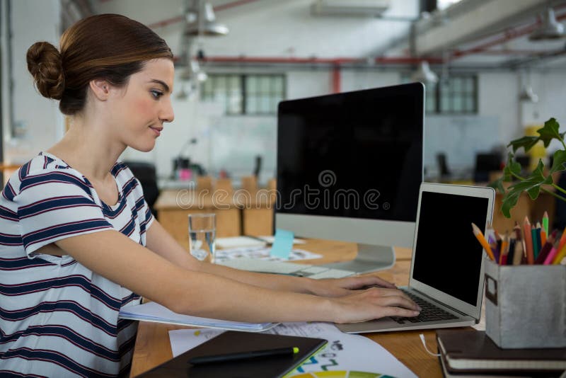 Female Graphic Designer Using Laptop Stock Image - Image of happy ...