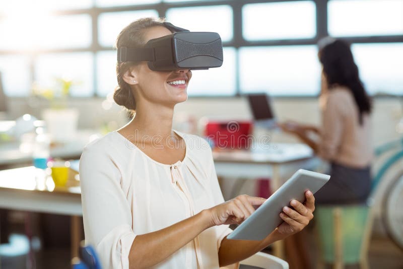 Female Graphic Designer in Virtual Reality Headset Using Digital Tablet ...