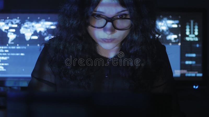 Bespectacled Woman Hacker Programmer Is Working On Computer In Cyber