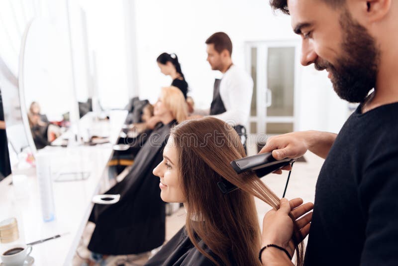 Female Hairdresser Straighten Brown Hair To Pretty Woman Using Hair