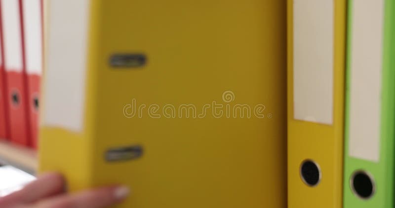 Female Hand of Accountant Pulls Binder Folder from Storage Shelf Stock ...