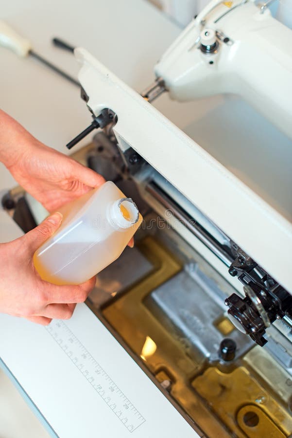 Female Hand Adding Oil in Sewing Machine. Stock Photo - Image of ...