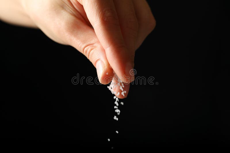 Female Hand Adding Salt on Black Background Stock Image - Image of ...