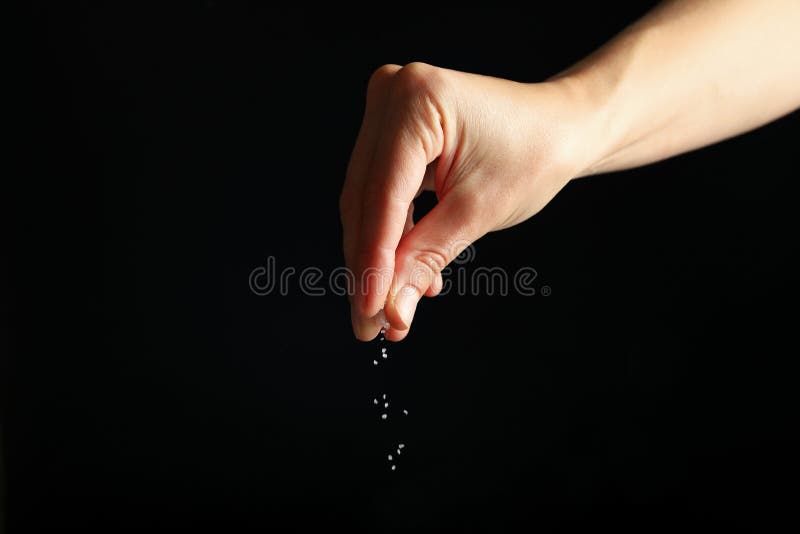 Female Hand Adding Salt on Black Background Stock Image - Image of hold ...