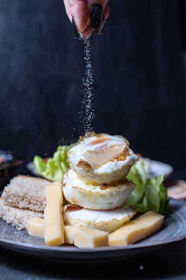 Female Hand Adding Salt To the Egg Breakfast Stock Image - Image of ...