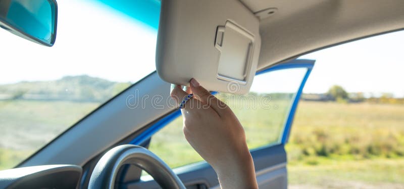Female Hand Adjusting Sun Visor in a Car Stock Image - Image of female ...