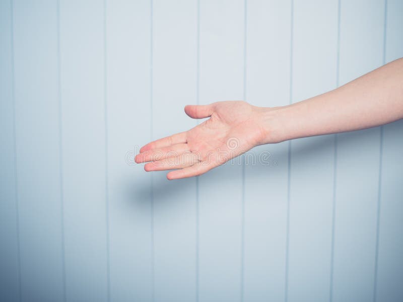 Female Hand Against Blue Wall Stock Photo - Image of hand, palm: 185141328