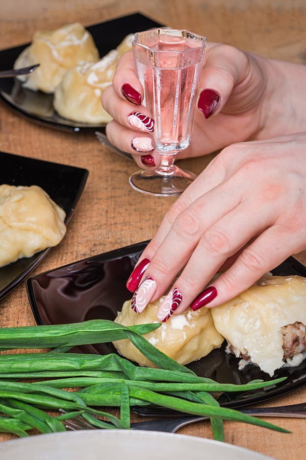 The Female Hand with Beautiful Manicure Keeps a Shot Glass with Vodka ...