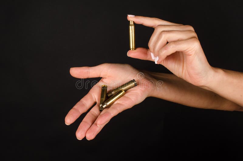 Female hand with bullets stock photo. Image of hazard - 152086128