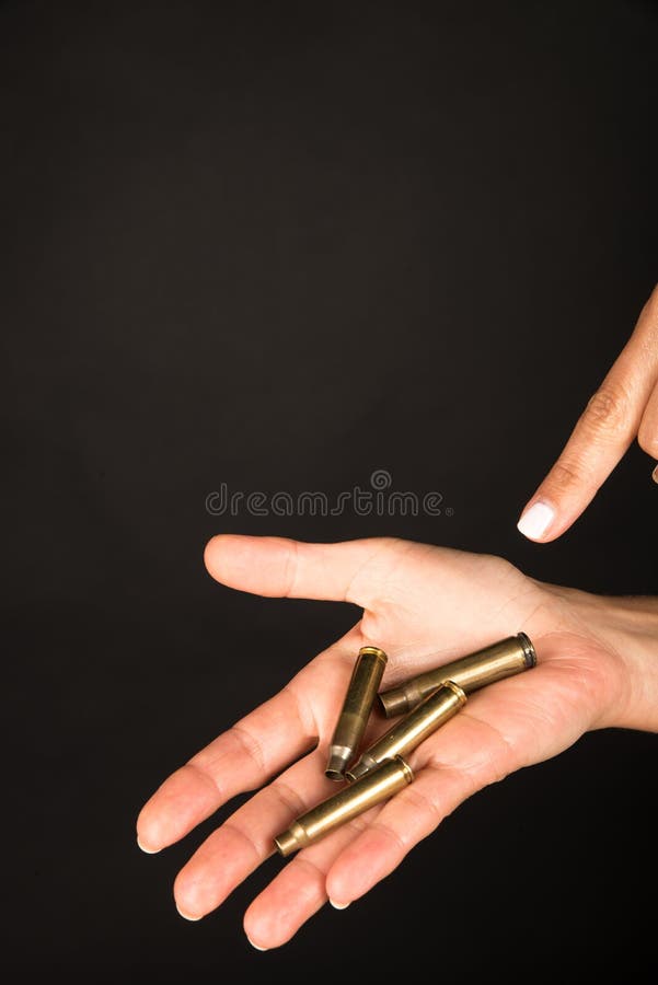 Female hand with bullets stock image. Image of hazard - 145792755