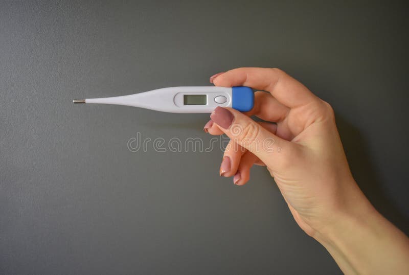 Female Hand with Electronic Thermometer on Dark Background Stock Image ...