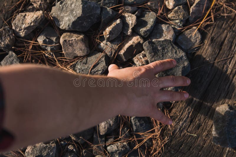 Female Hand Gathering a Rock on the Train Tracks Stock Image - Image of ...
