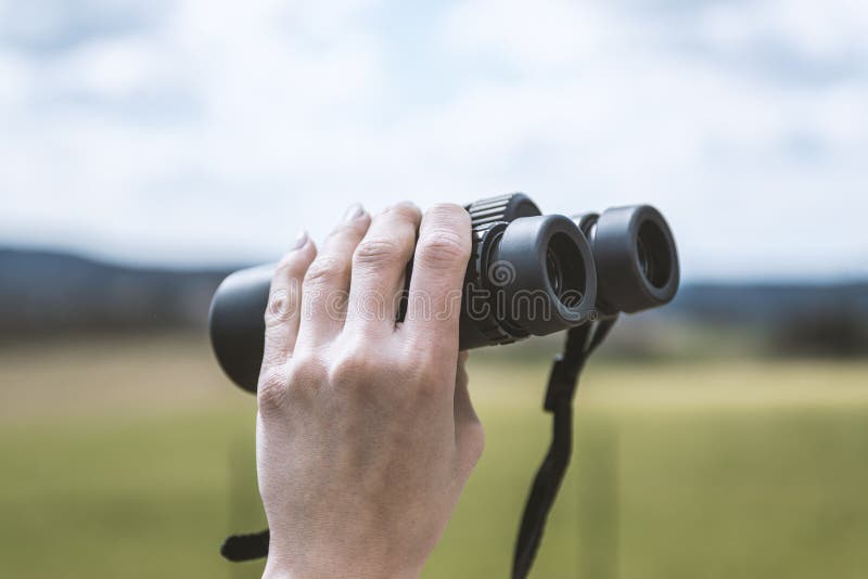 Hand holding a binoculars stock image. Image of adventure - 260439179