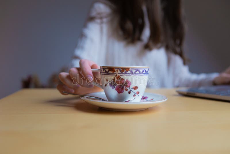 A Female Hand Holding a Cup Whilst Working Stock Photo - Image of pause ...