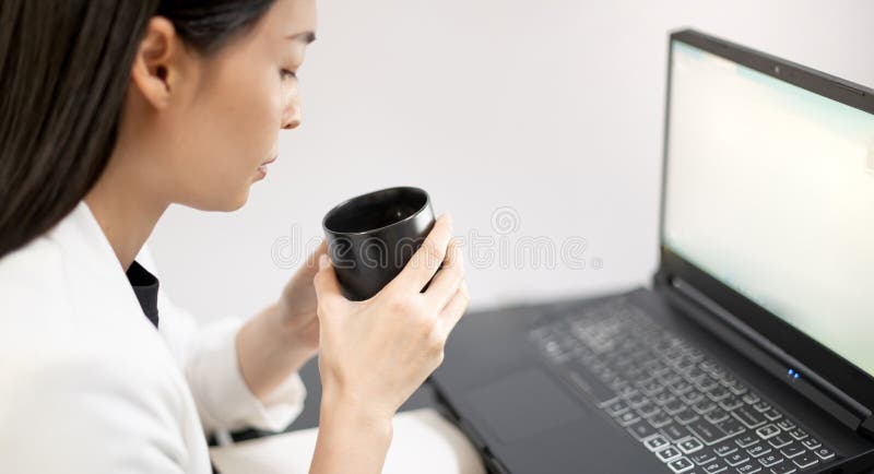 Female Hand Holding Glass while Working with the Laptop Computer Stock ...