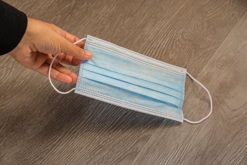 Female Hand Place a Surgery Mask on a Wooden Table Stock Image - Image ...