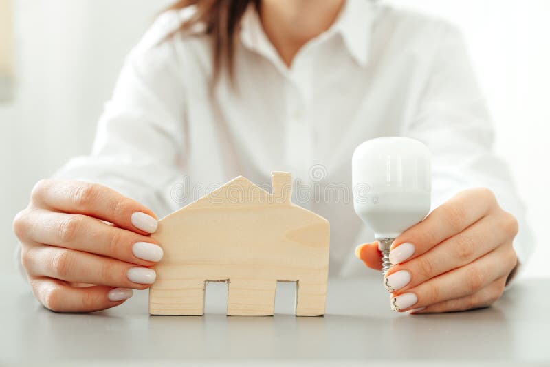 Female Hand Holding a Light Bulb Above the Table Stock Image - Image of ...