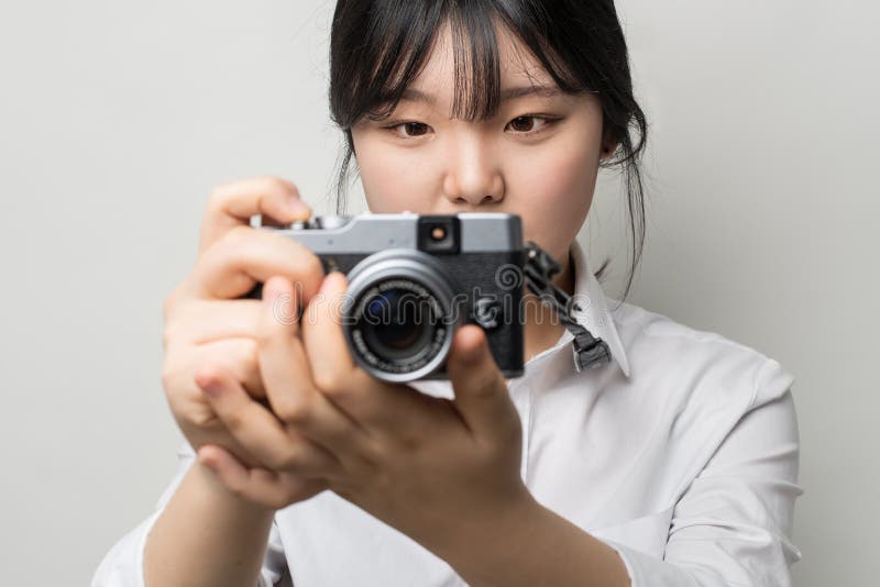 Female Hand Holding Modern Camera Mirrorless Camera. Camera in Hand ...
