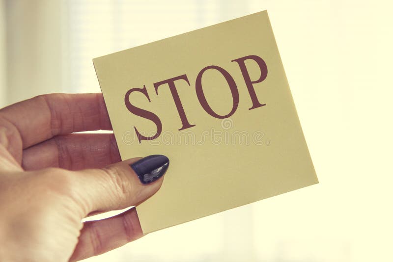 Female Hand Holding Paper with Stop Letter. Stock Image - Image of ...