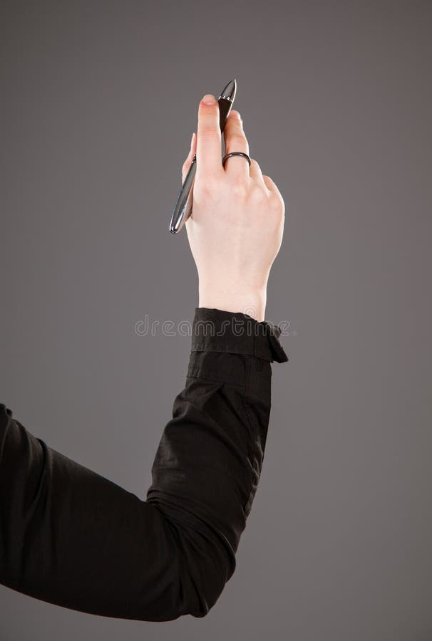 Female hand holding a pen stock photo. Image of holding - 68265752