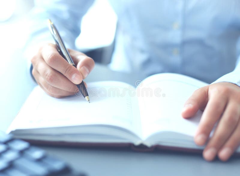 Female Hand Holding Pen Ready To Make Note in Opened Notebook Sheet ...