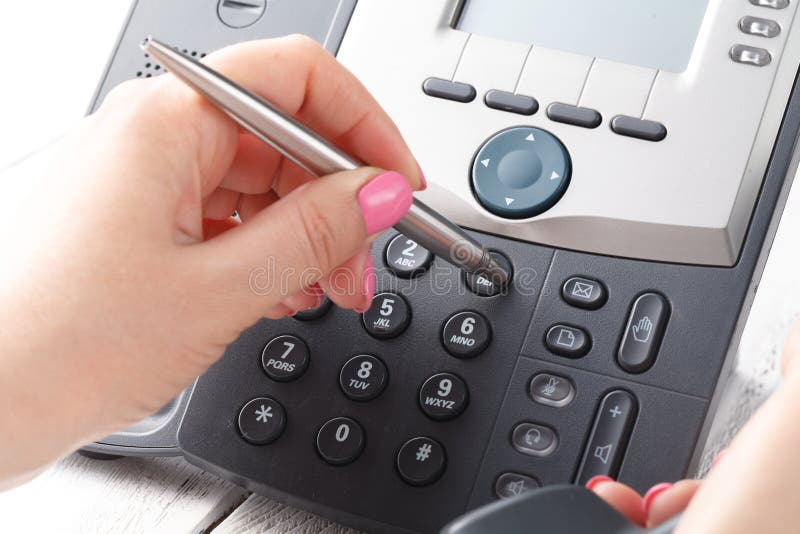 Female Hand Holding Phone Receiver and Dialing Number Stock Image ...