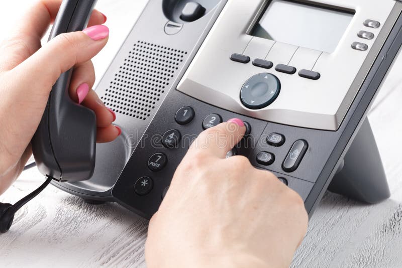 Female Hand Holding Phone Receiver and Dialing Number Stock Photo ...