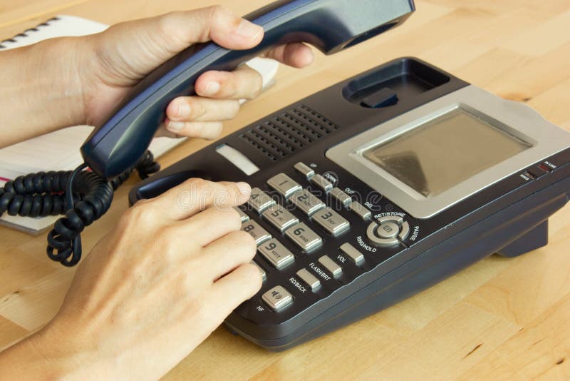 Female Hand Holding Phone Receiver and Dialing Number Stock Image ...