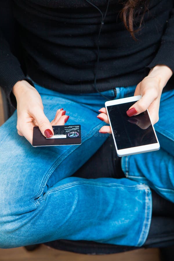 Female Hand Holding Plastic Credit Card and Using Smartphone Stock ...