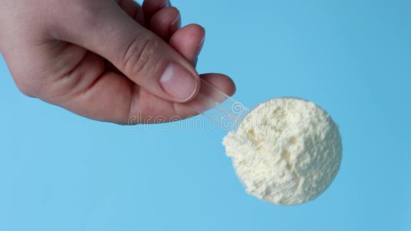 Man Holding a Scoop of Soy Protein Isolate Powder with Chocolate in His ...