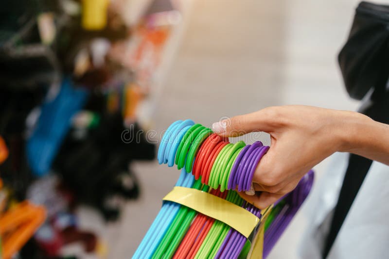 Female Hand Holding a Set of Hangers Stock Image - Image of ...