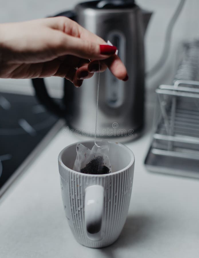 Female Hand Holding a Tea Bag Stock Photo - Image of stove, cozy: 136792480