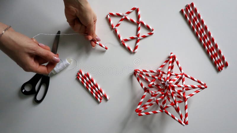 A Female Hand Holds a Needle with a Thread. Handmade Stars from ...