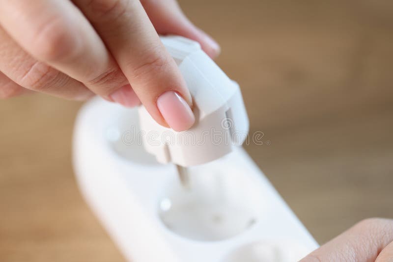 Female Hand Inserting Electric Plug into White Socket Stock Photo ...