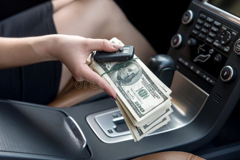 Female Hand Inside Car Offering Keys and Dollars Stock Image - Image of ...