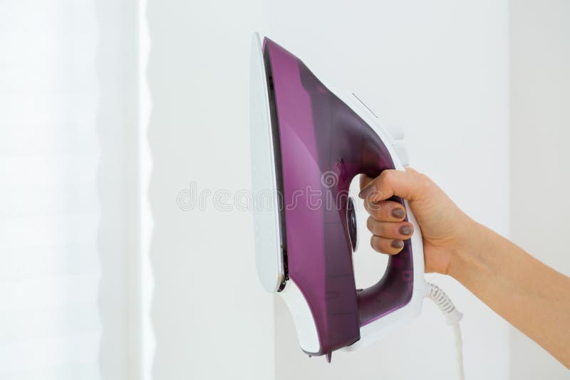 Female hand with iron stock photo. Image of active, housework - 46981126