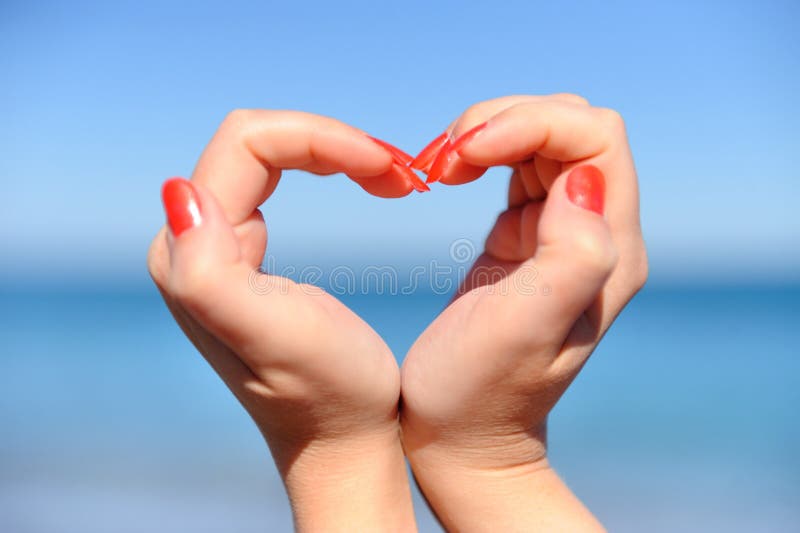 Female Hand Making a Heart Shape Against Stock Image - Image of horizon ...