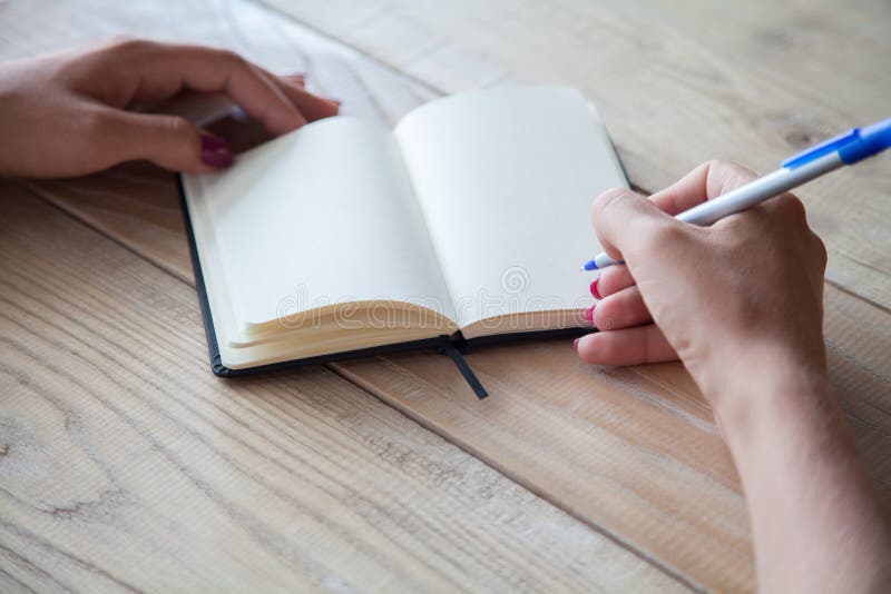 Female Hand Making Notes in a Notebook. Stock Image - Image of ...