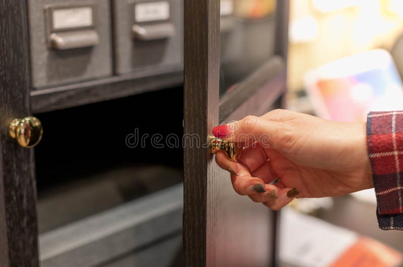 .Female Hand Opening White Document Cupboard for Choosing the Document ...