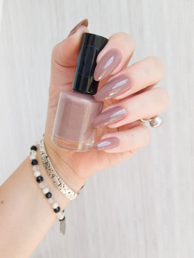 Female Hand with Pale Light Long Nails and a Bottle Stock Image - Image ...