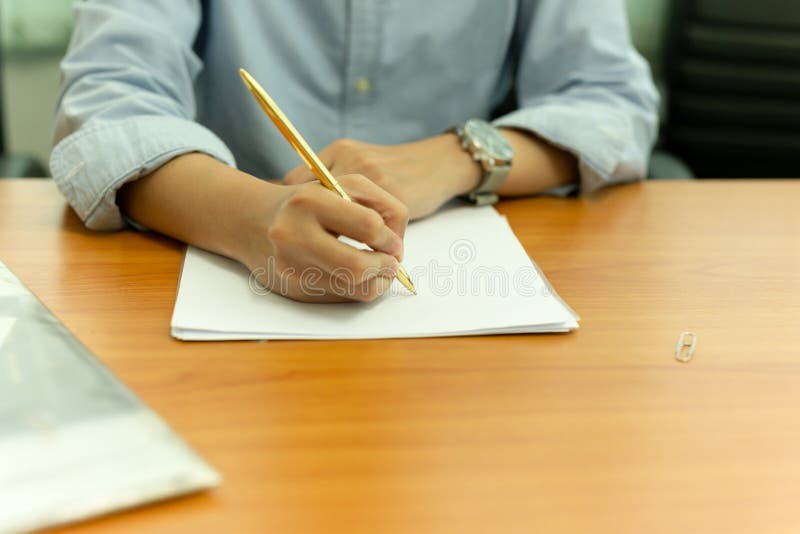 Female Hand with Pen on Document Form on Wooden Table. Stock Image ...