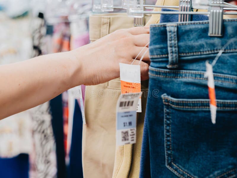 Female Hand Picking through Clothes on a Store Rack Stock Photo - Image ...