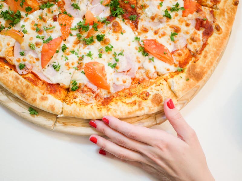 Female Hand and Pizza. Kind of Pizza with Bacon Tomatoes and Herbs ...