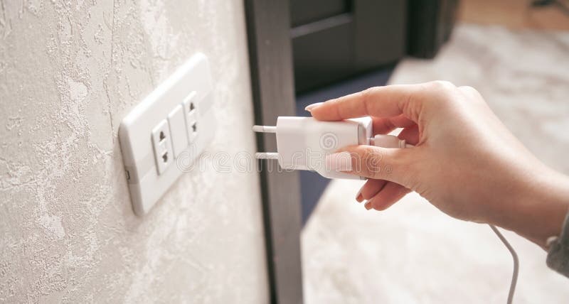Female Hand Plugs the Phone Charger into the Socket Stock Image - Image ...