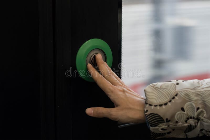 Female Hand Presses the Door Control Green Button To Open Doors in ...